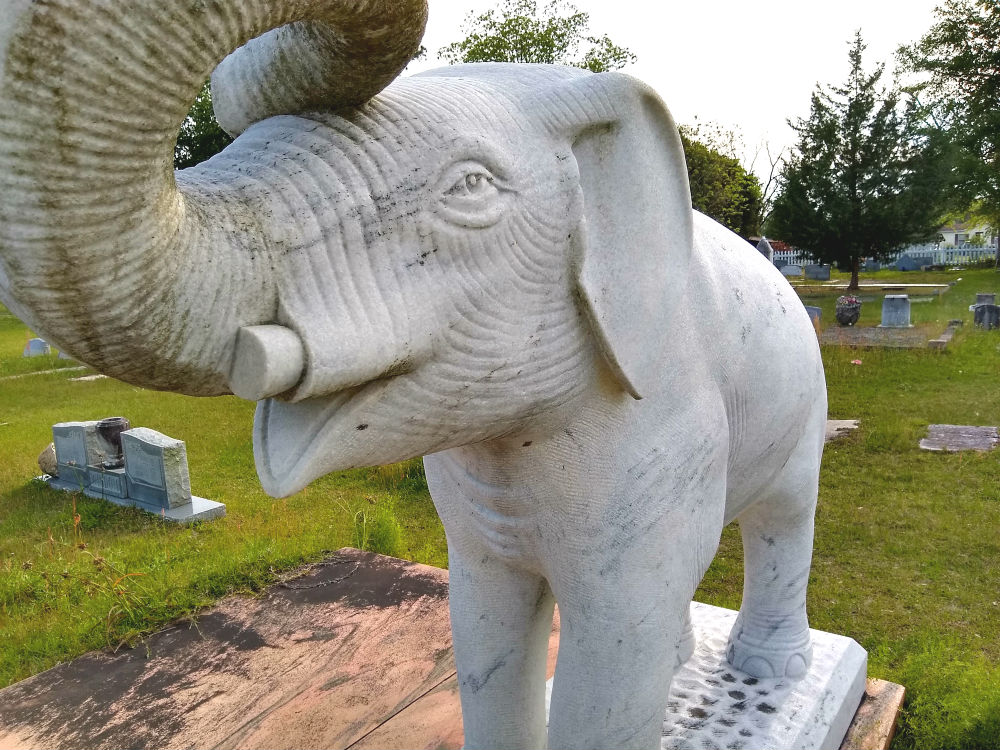 This grave in Georgia is marked by a life-sized baby elephant statue ...