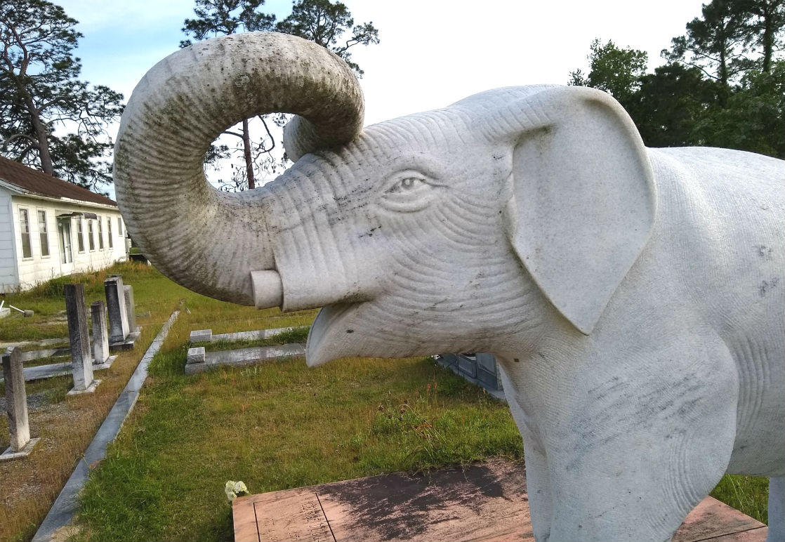 This grave in Georgia is marked by a life-sized baby elephant statue ...